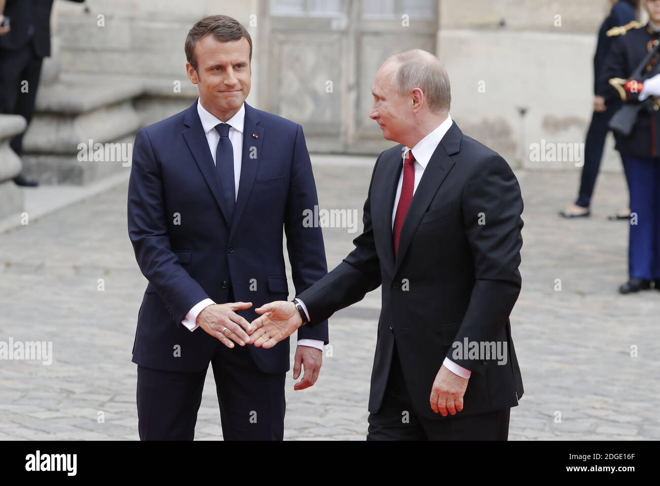 French President Emmanuel Macron shakes hand with Russian President ...