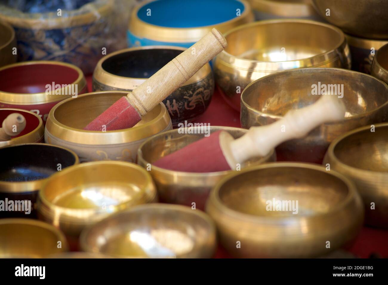 Buddhist singing bowls and wooden strikers for sale on a market stall ...