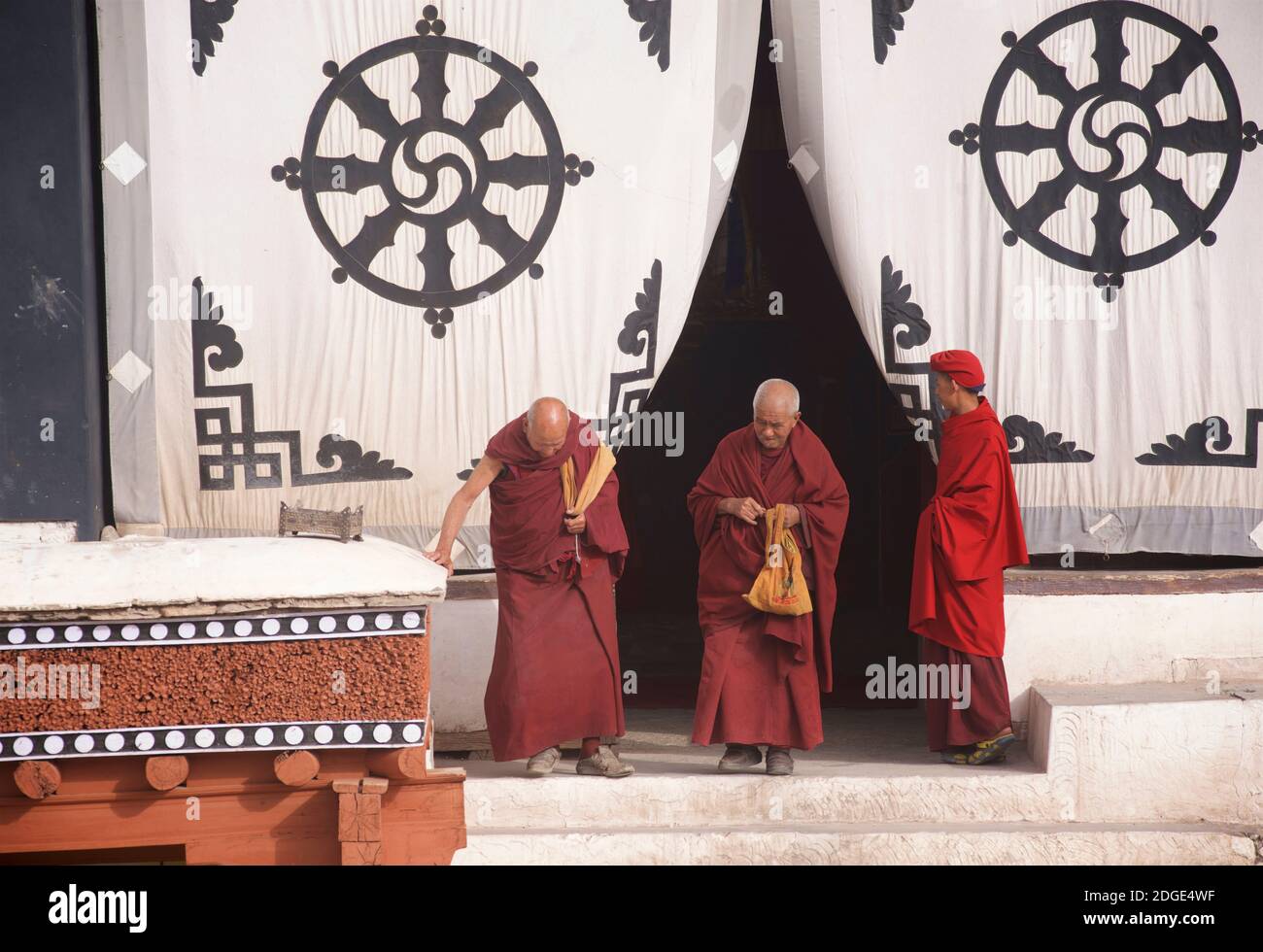 Early morning at Hemis monastery. Monks outside leaving the prayer hall ...