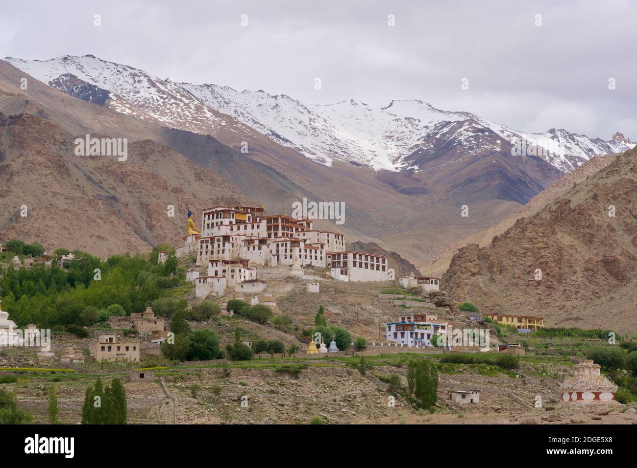 Likir monastery set amongst irrigated fields with mountain peaks beyond ...