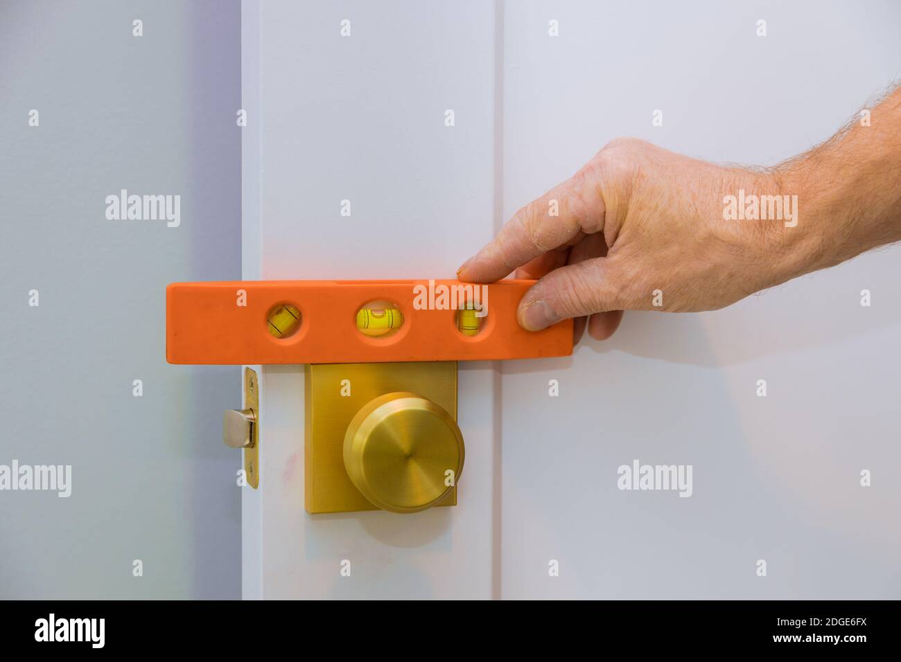 Male carpenter fixing lock in door with home Stock Photo - Alamy