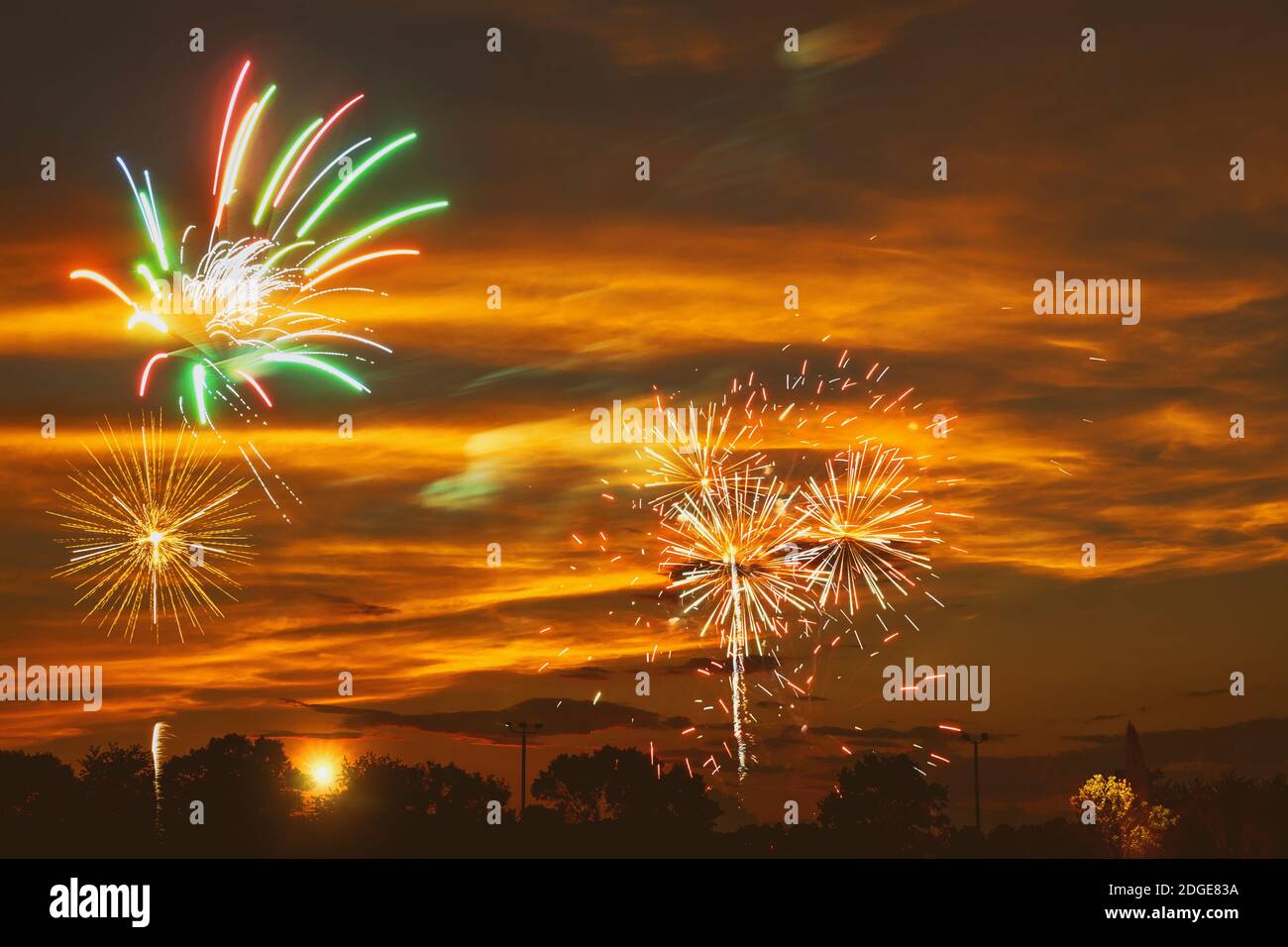 Brightly colorful fireworks in the sunset sky Stock Photo - Alamy