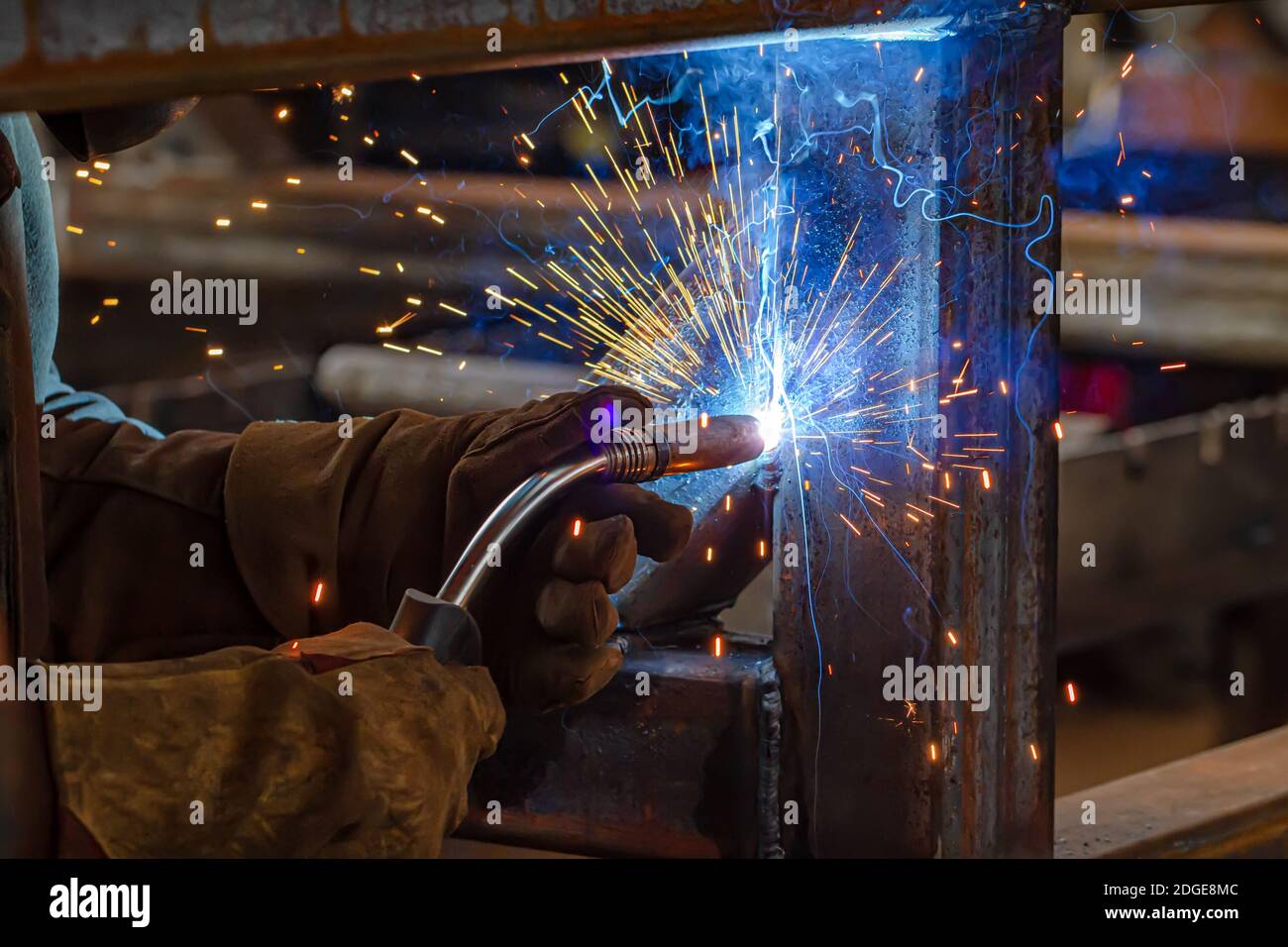 Semi-automatic welding with sparks and smoke Stock Photo - Alamy