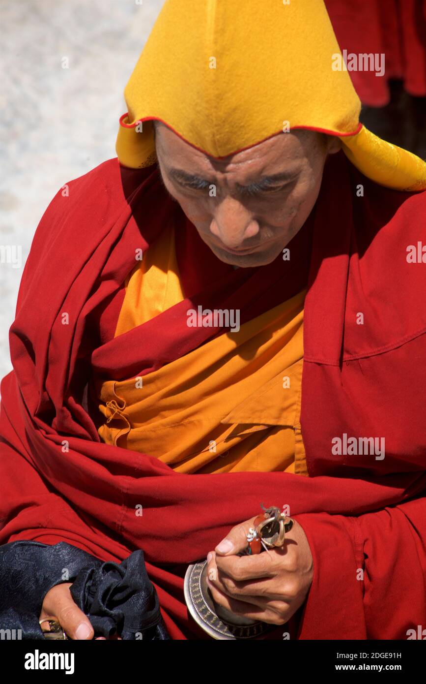 Yellow hat Buddhist Lama in monastic attire and bell , Karsha monastery ...
