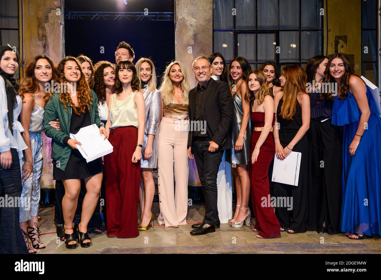 Fashion designer Elie Saab poses with the first 16 graduates of LAU ...