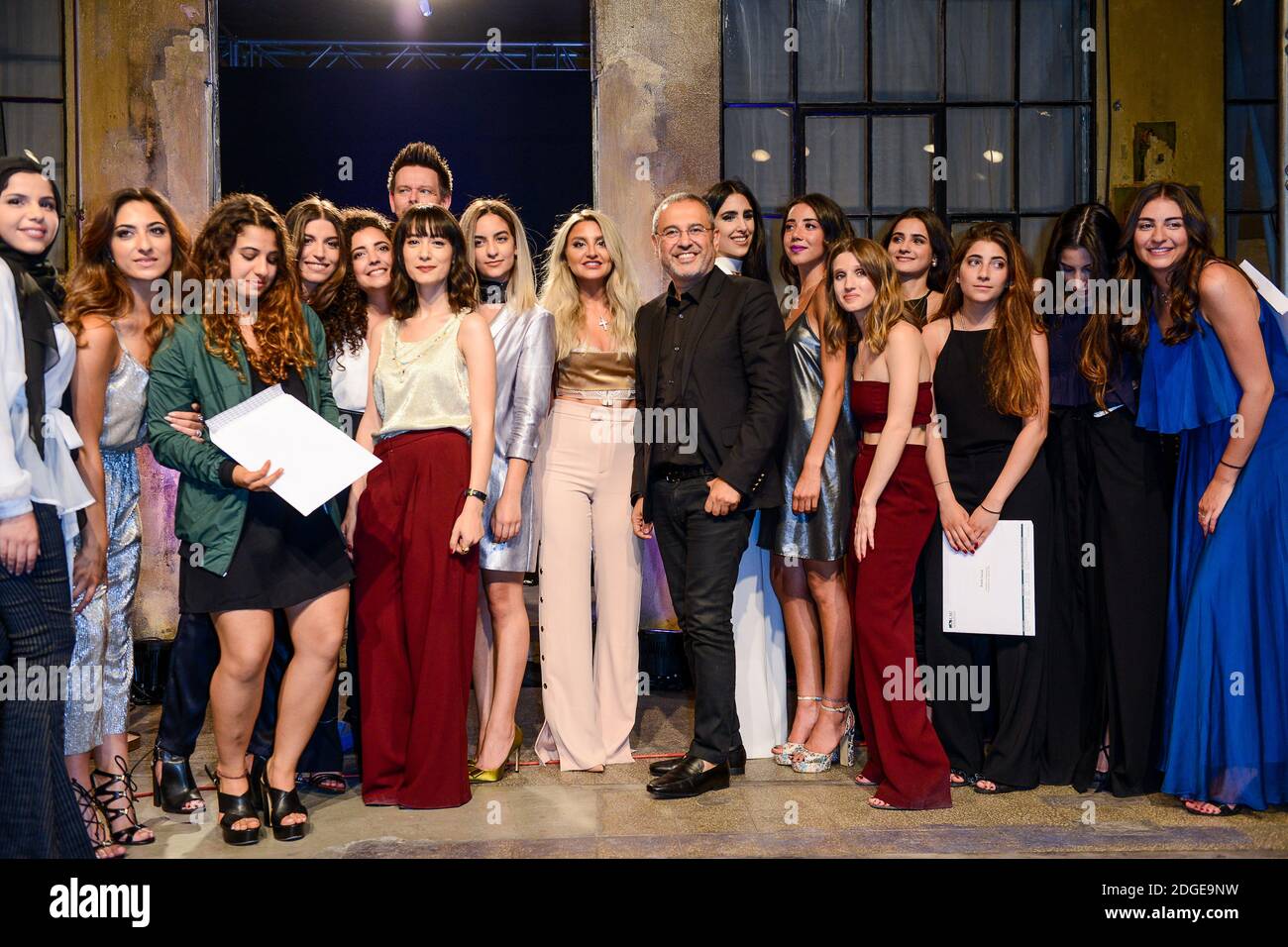 Fashion designer Elie Saab poses with the first 16 graduates of LAU ...