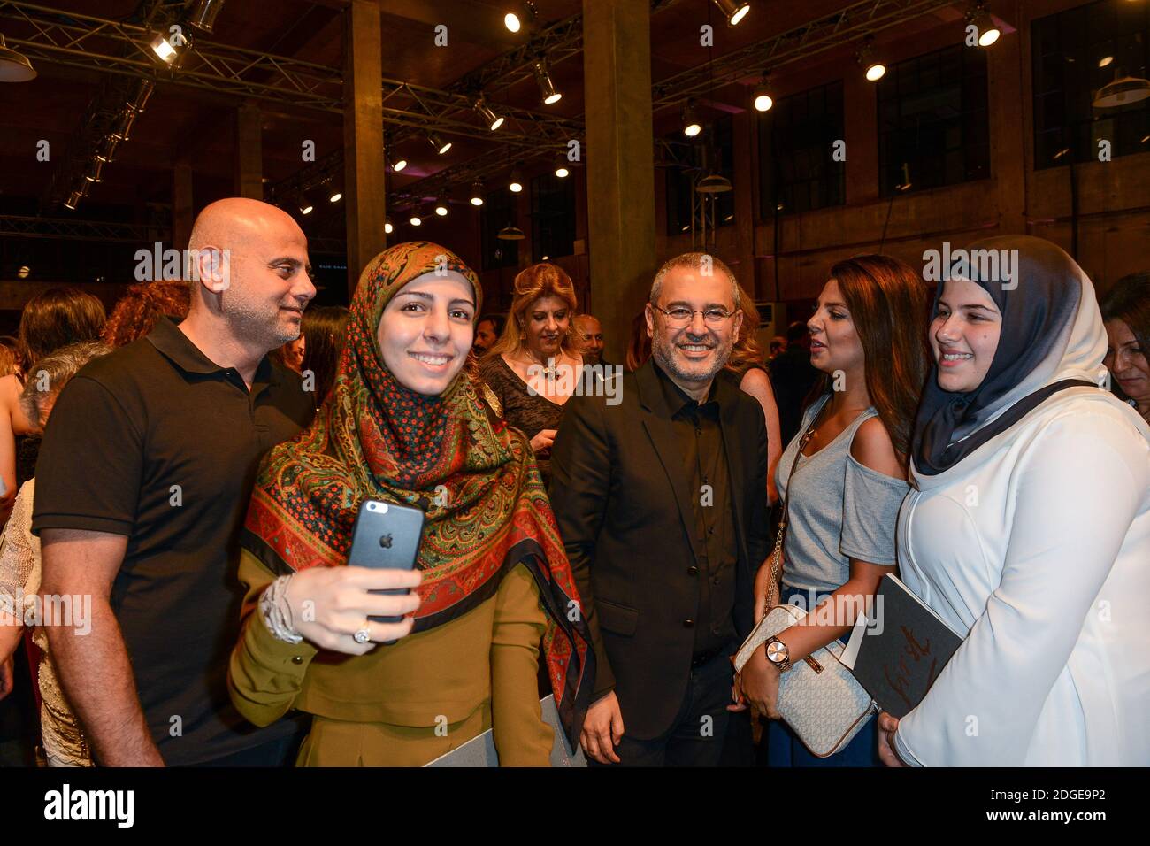 Fashion designer Elie Saab with students after the presentation of the ...