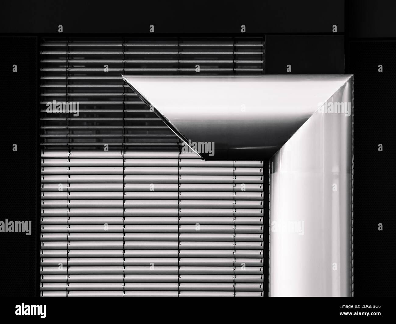 A grayscale shot of a large silver exhaustion pipe of a machine with ...