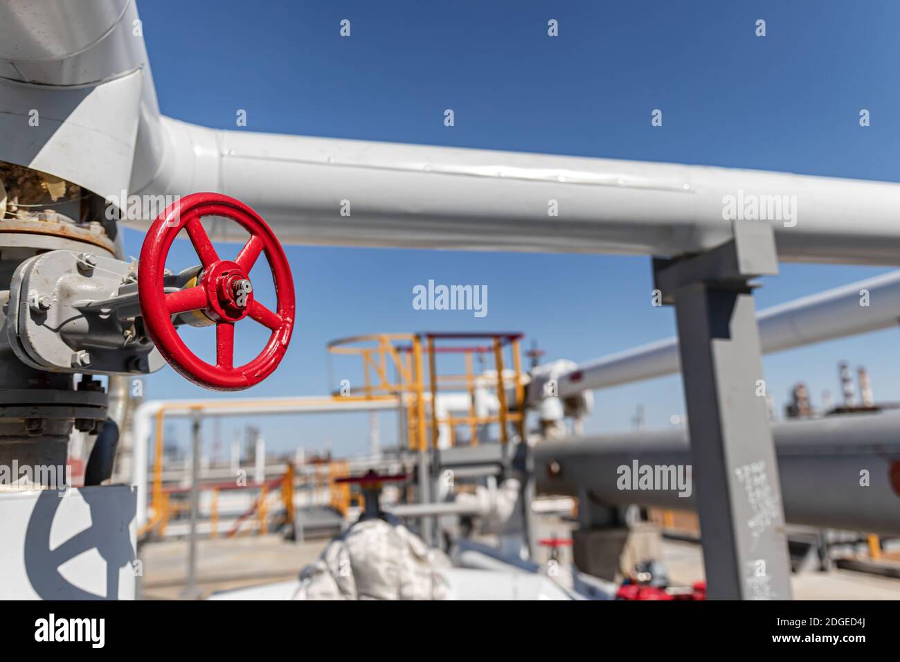 New shut-off valves with red flywheel installed on new process pipeline ...