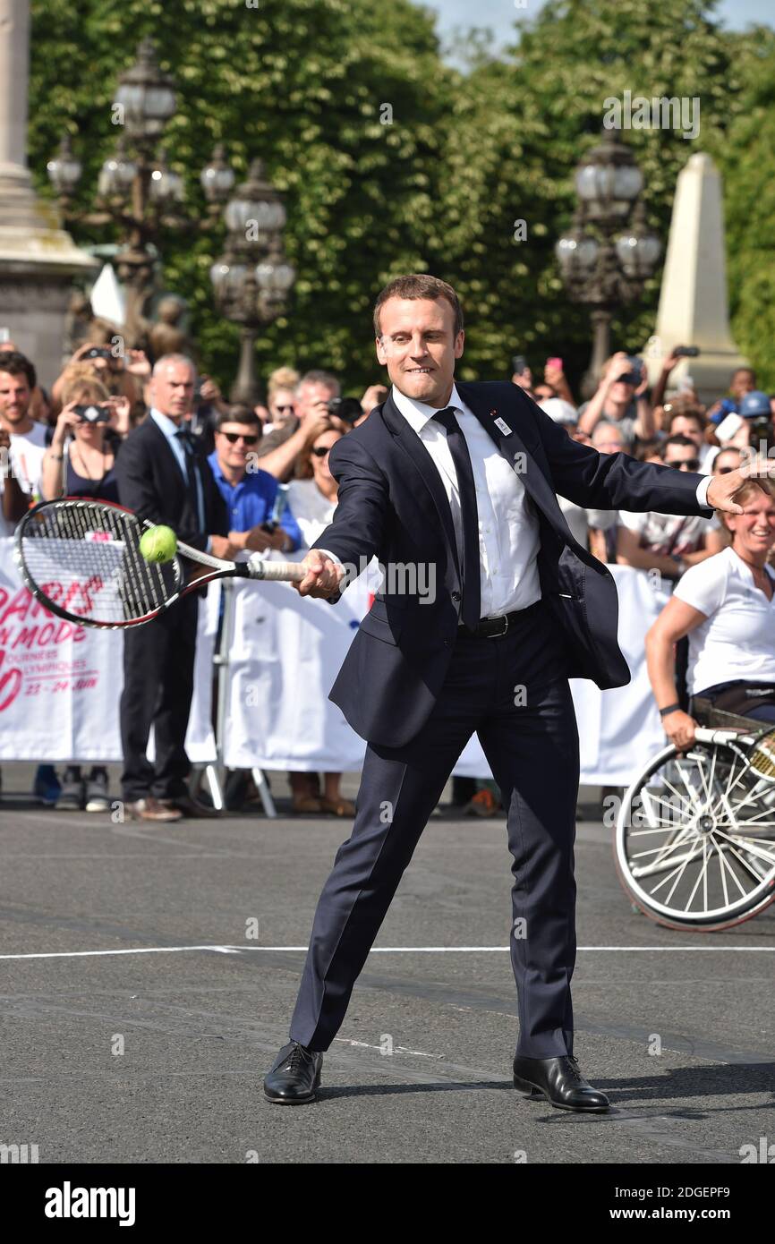 French President Emmanuel Macron plays tennis during a visit to a site ...