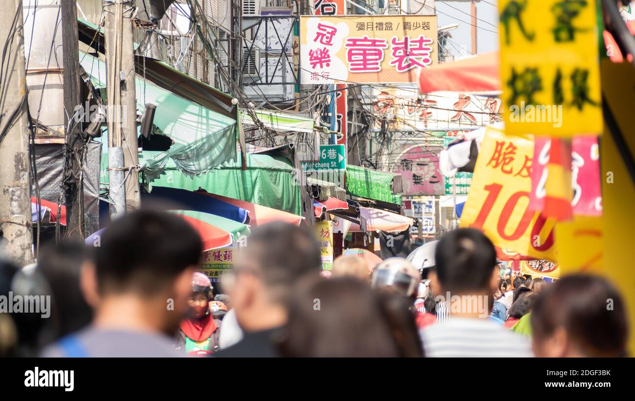 People walk and shopping in the traditional market at Puli town Stock ...