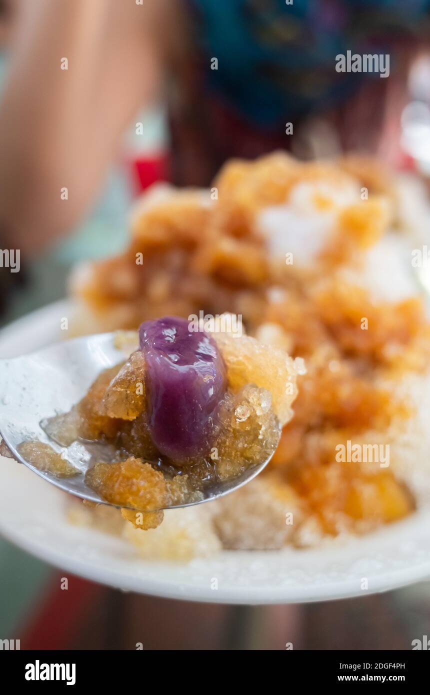 Eating shaved ice with colorful dessert Stock Photo - Alamy