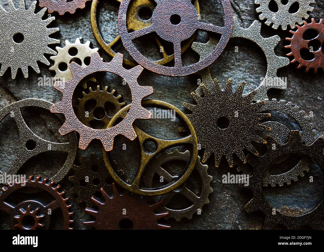 Assorted machine gears and components background Stock Photo - Alamy