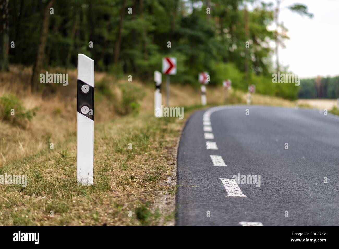 Country road with a sharp turn Stock Photo - Alamy
