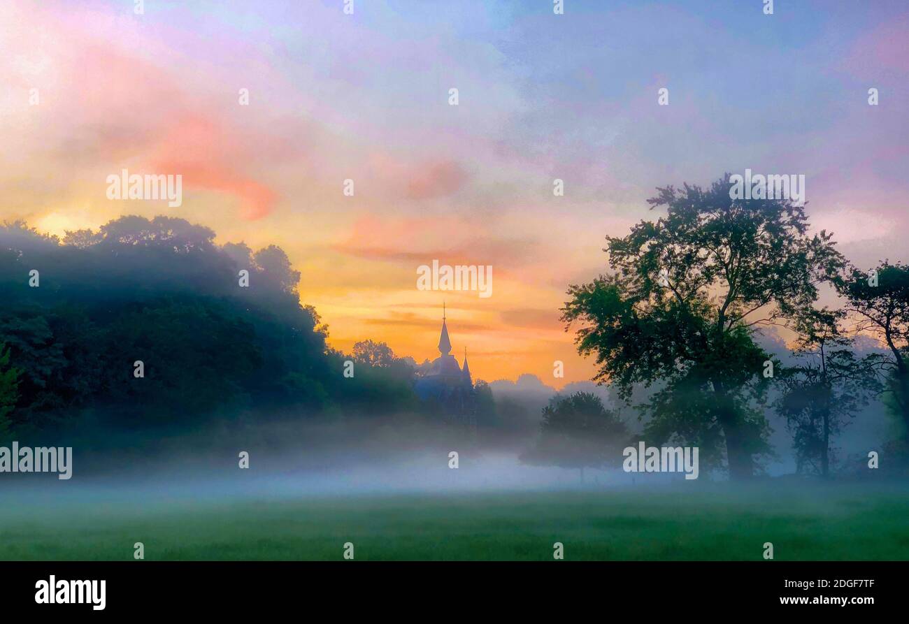 Colorful glowing sunrise over a distant castle Stock Photo - Alamy