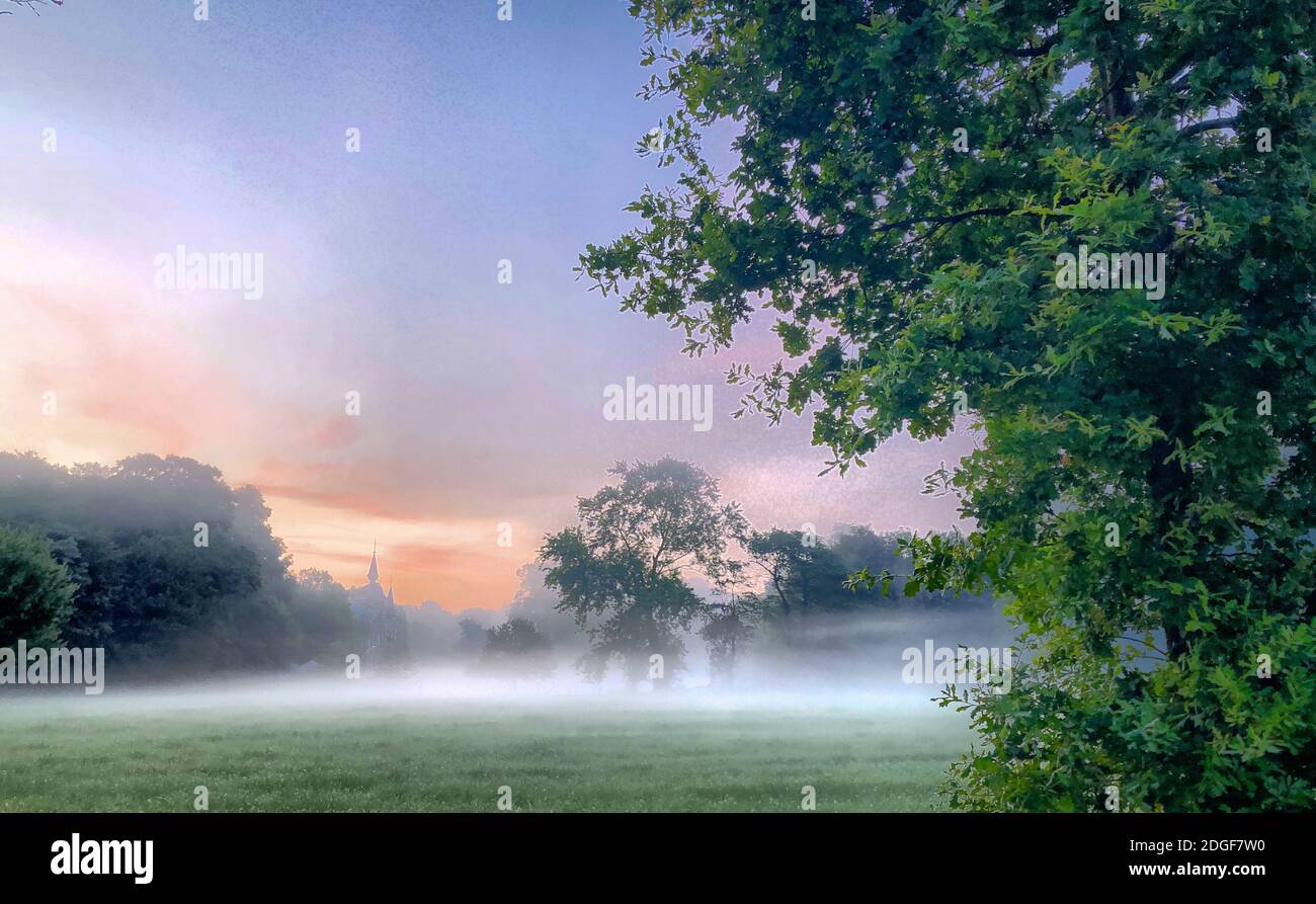 Colorful glowing sunrise over a distant castle Stock Photo - Alamy