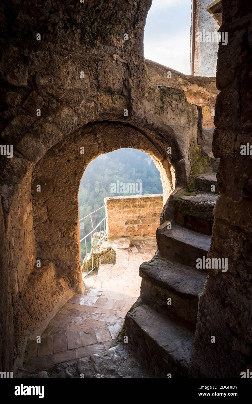 Steps inside the tower with access to a cliff in front of a mountain ...