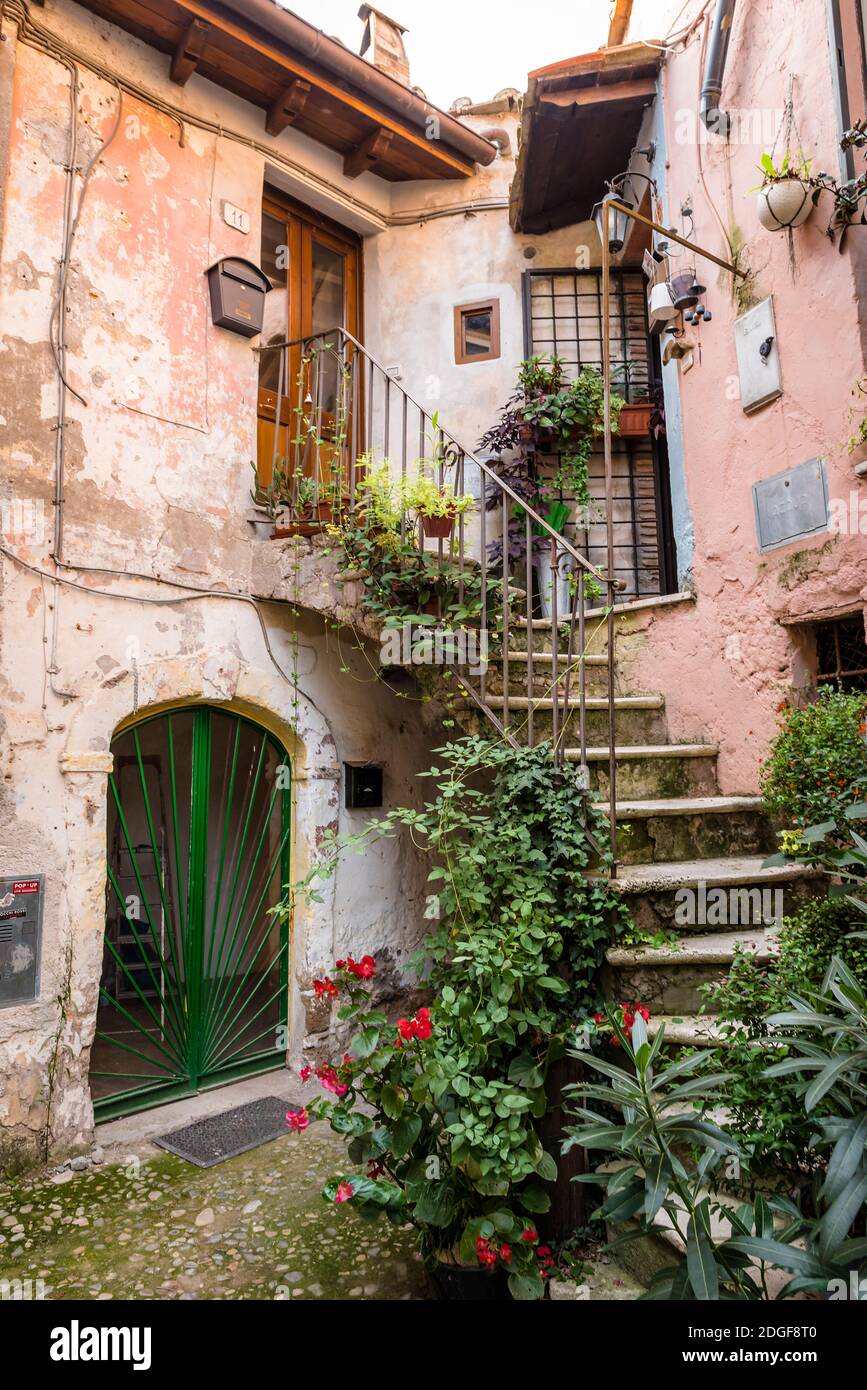 Old flaky house with the dead vines, a stone staircase and pots in the ...