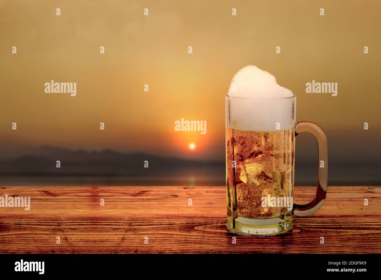 The glass of cold beer on the table with a sunset sky background Stock ...