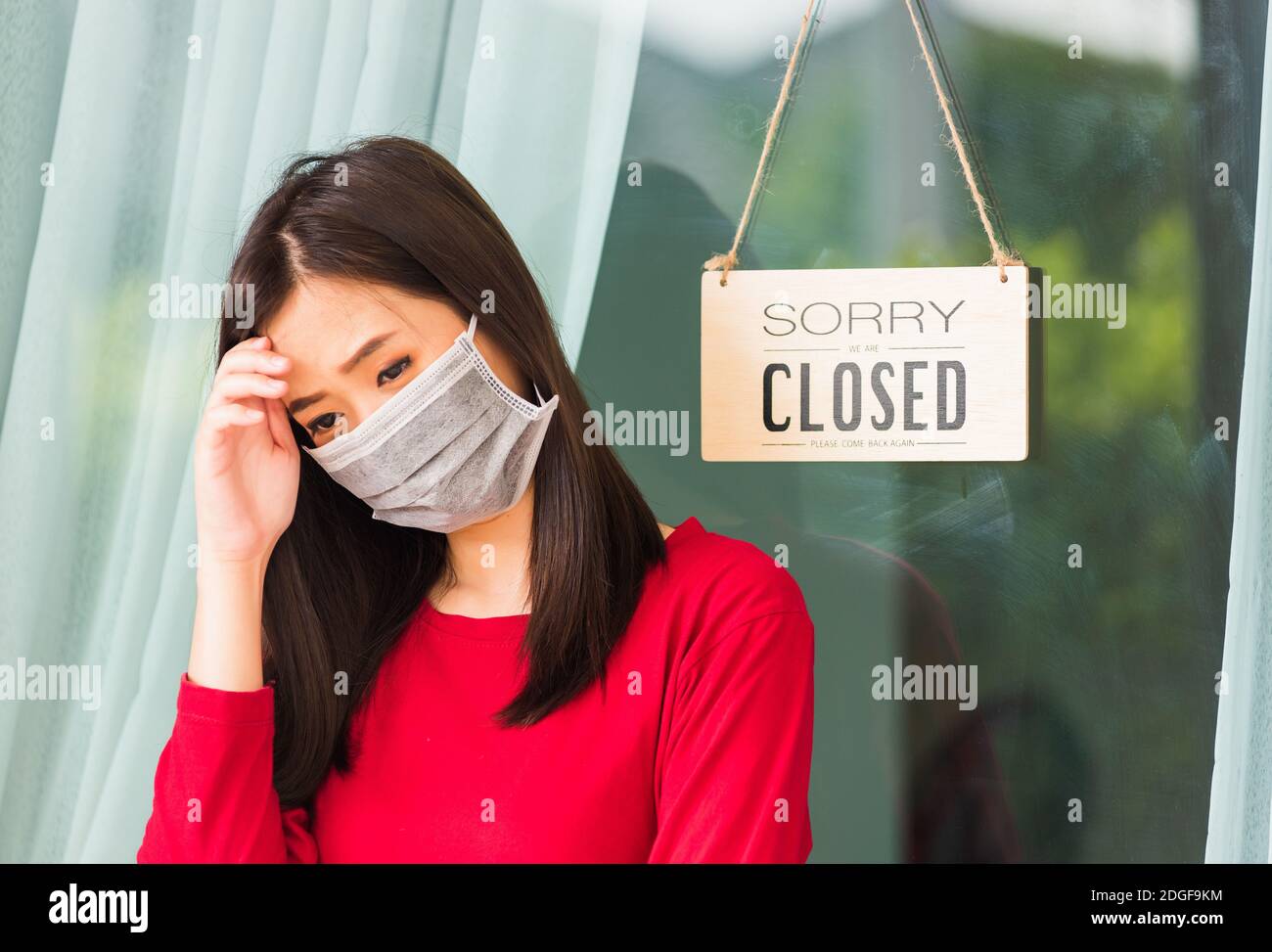 Asian young woman wear face mask protect she sad notice sign wood board ...