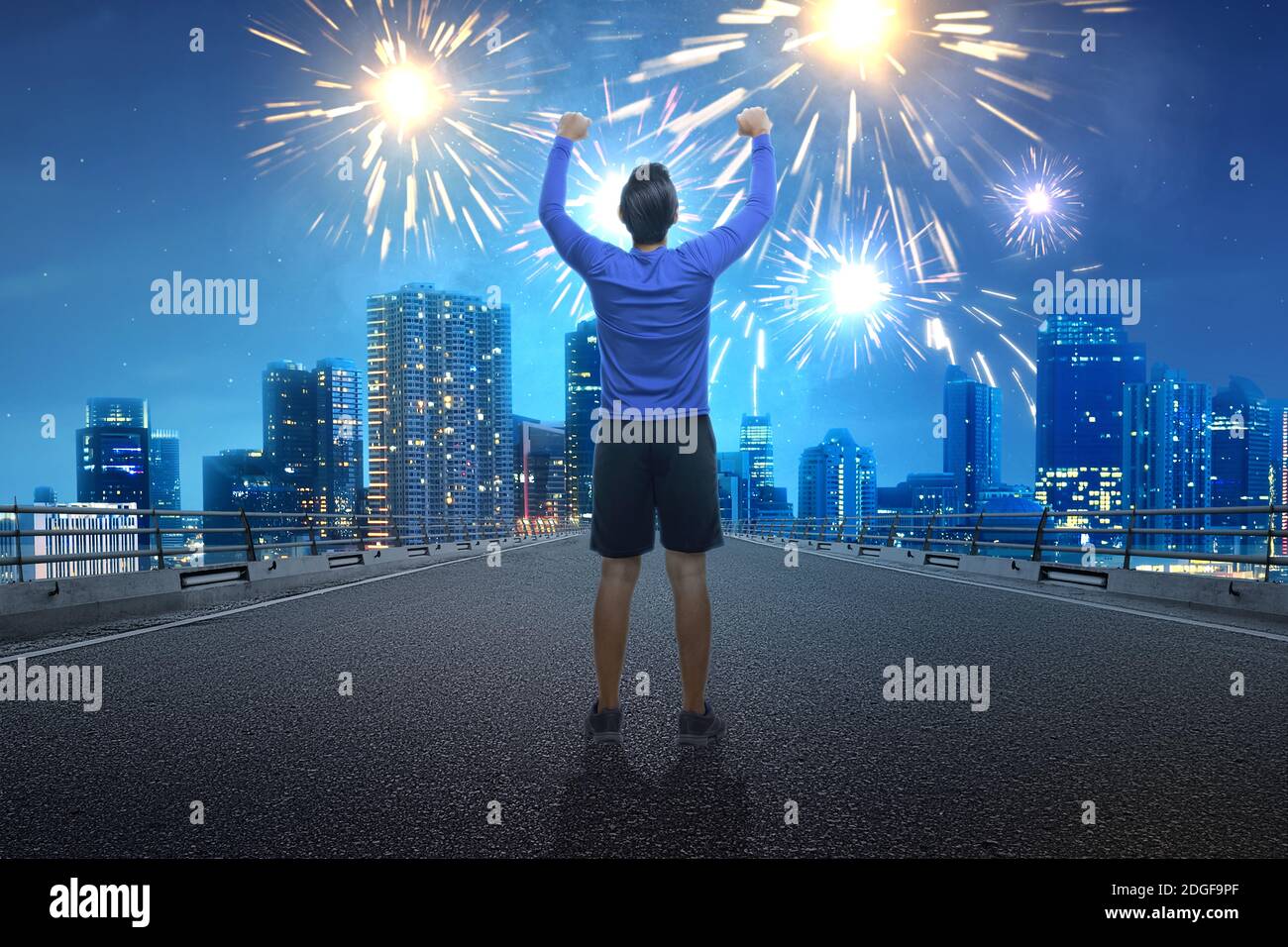 Rear view of Asian runner man with excited expression after a run on ...