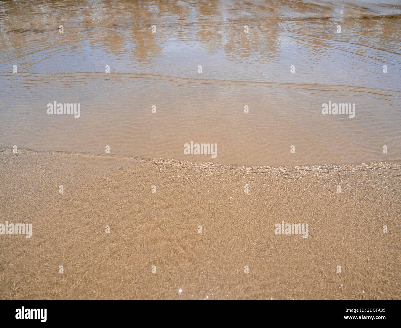 Light reflection on the surface of movement sea on sand beach Stock ...