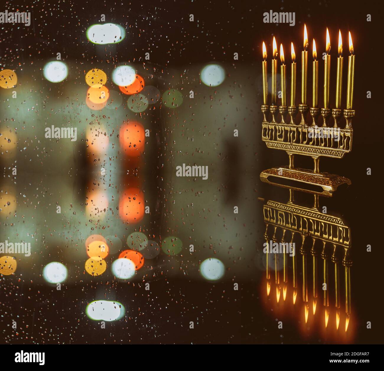 Burning menorah with golden candles and confetti defocused light ...
