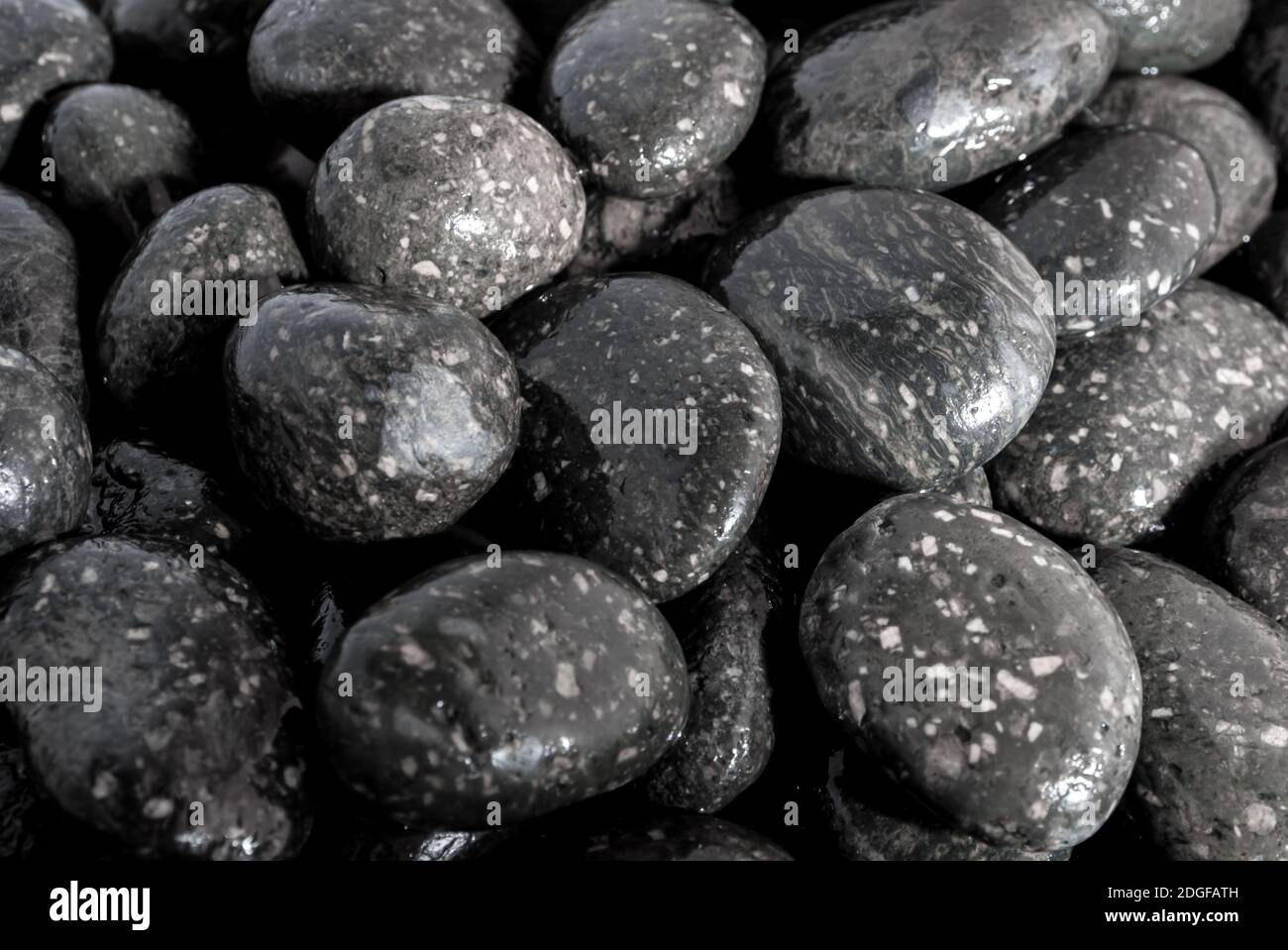 Wet surface of black river stone on ground beside the waterfall Stock ...