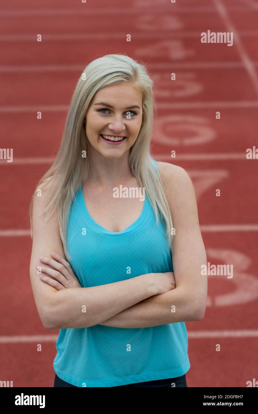 A Young Athletic College Athlete Prepares For A Track Meet At A ...