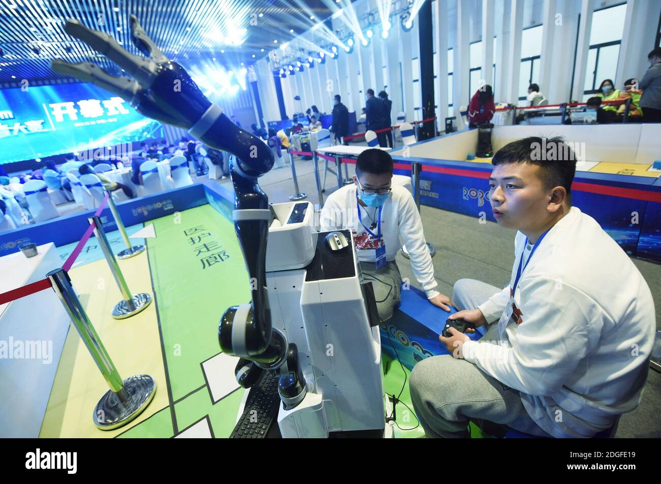 Participants operate a robot at the 2020 RoboCom in Hangzhou city, east ...
