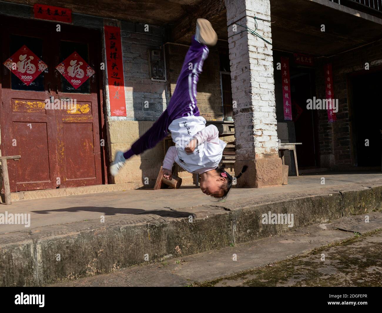 Xiao Douya practices flip in the yard, Cangxi county, Guangyuan city ...