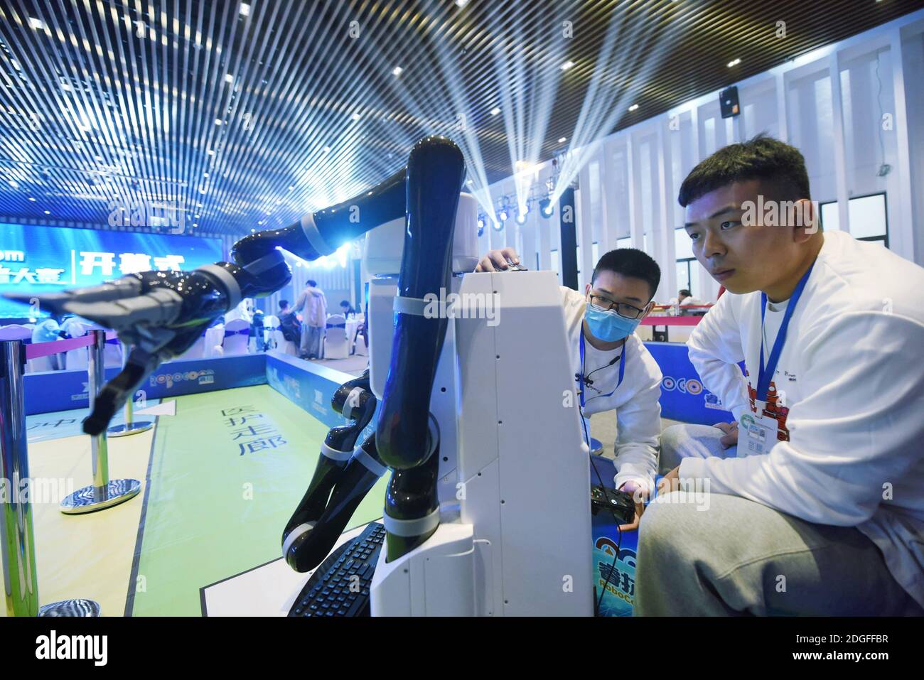 Participants operate a robot at the 2020 RoboCom in Hangzhou city, east ...