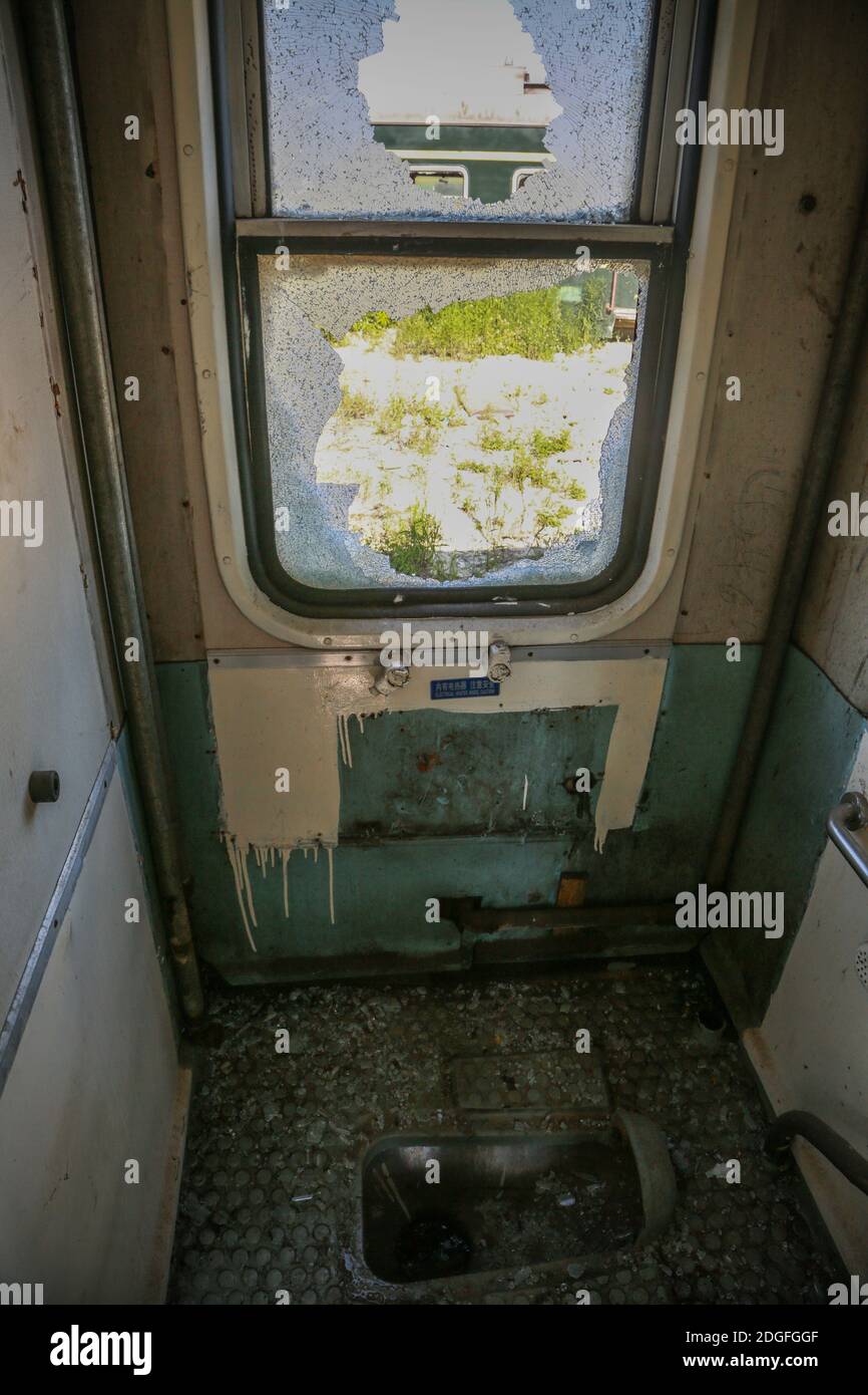 There are piles of abandoned green-skinned trains on the train ...