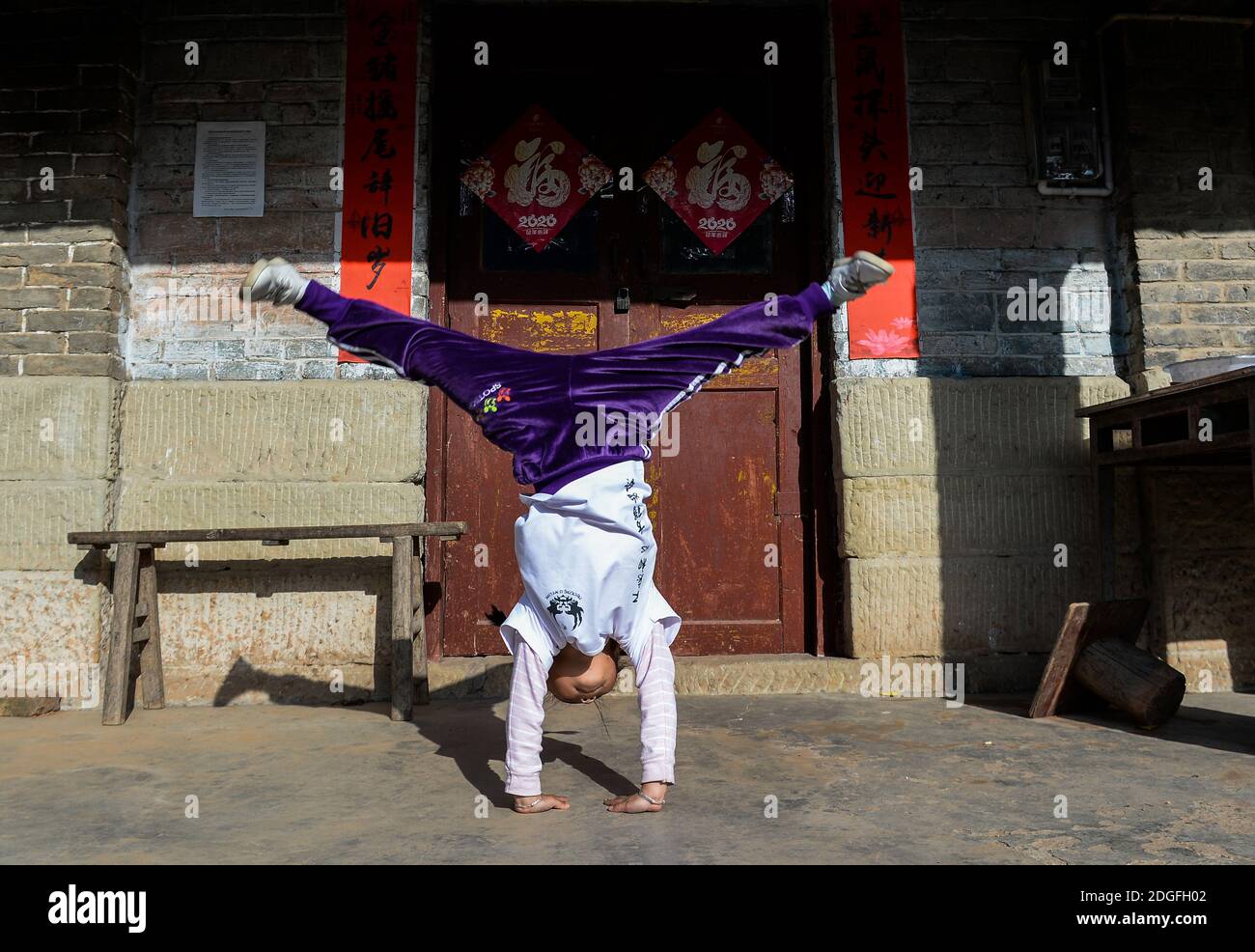 Xiao Douya practices flip in the yard, Cangxi county, Guangyuan city ...