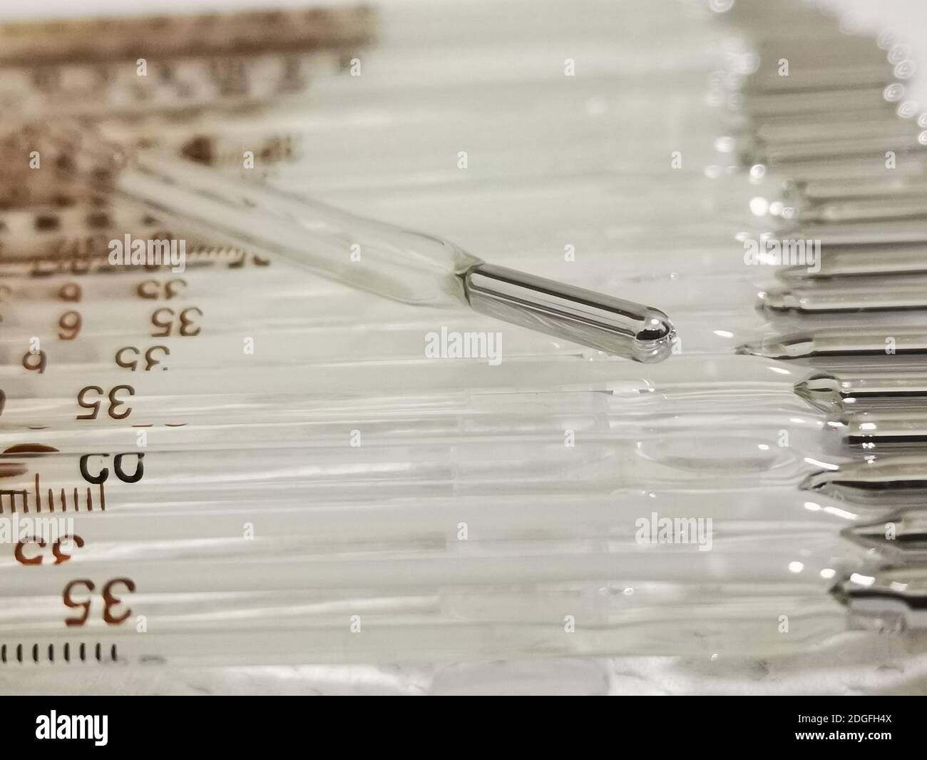In this unlocated photo, a person shows mercury thermometers in China ...