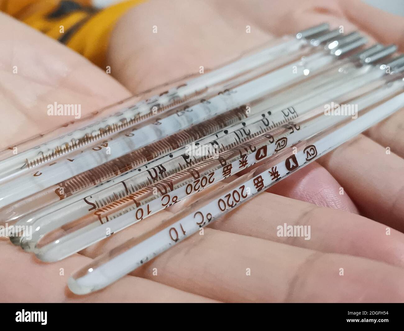In this unlocated photo, a person shows mercury thermometers in China ...