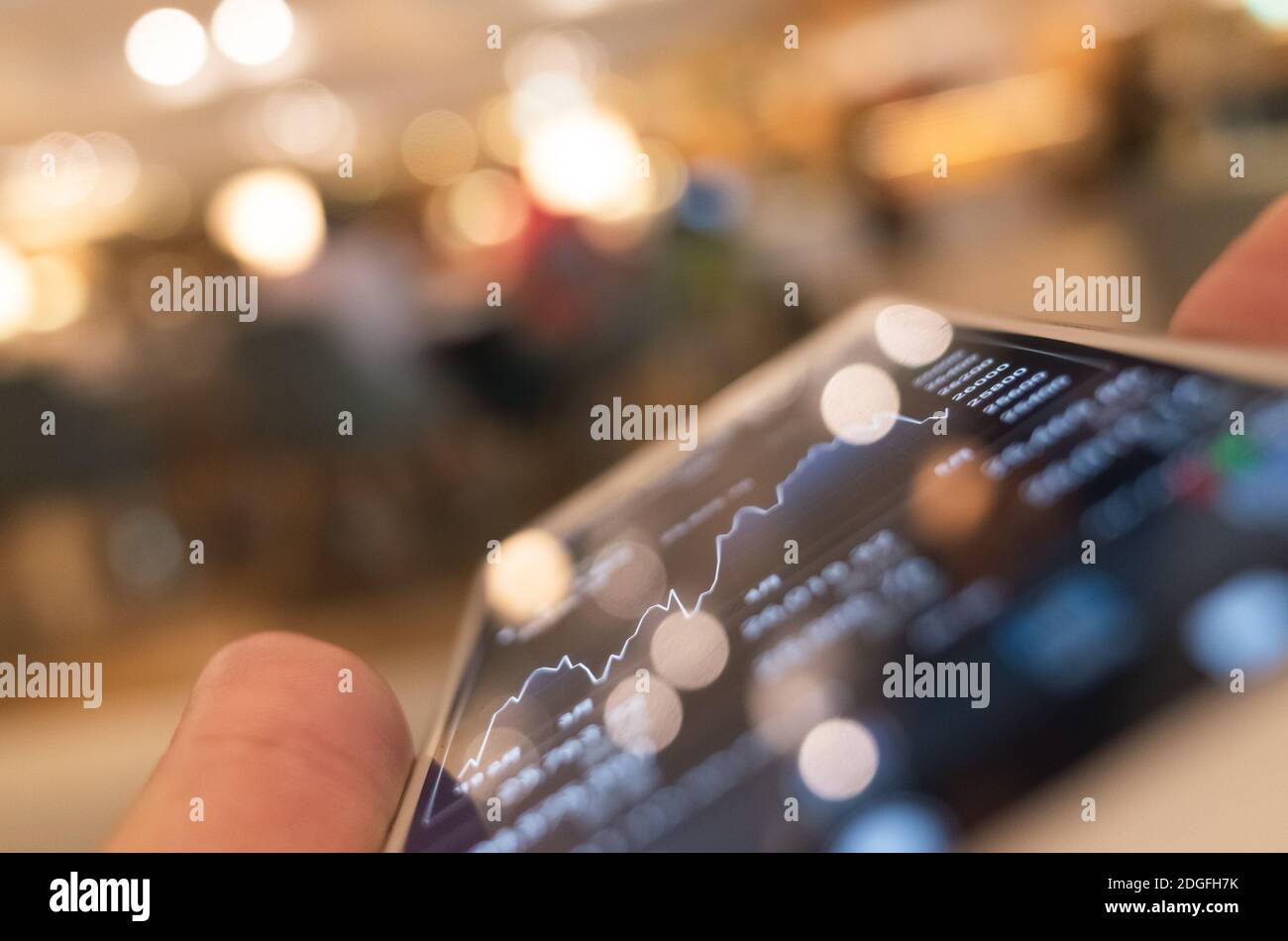 Using a mobile device to check market data Stock Photo - Alamy