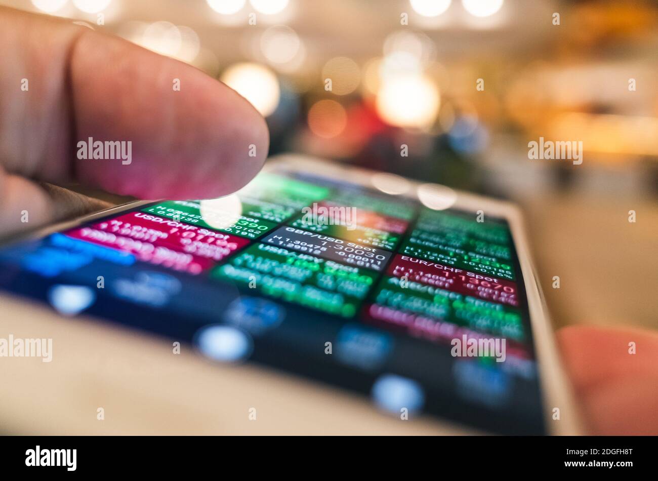 Using a mobile device to check market data Stock Photo - Alamy
