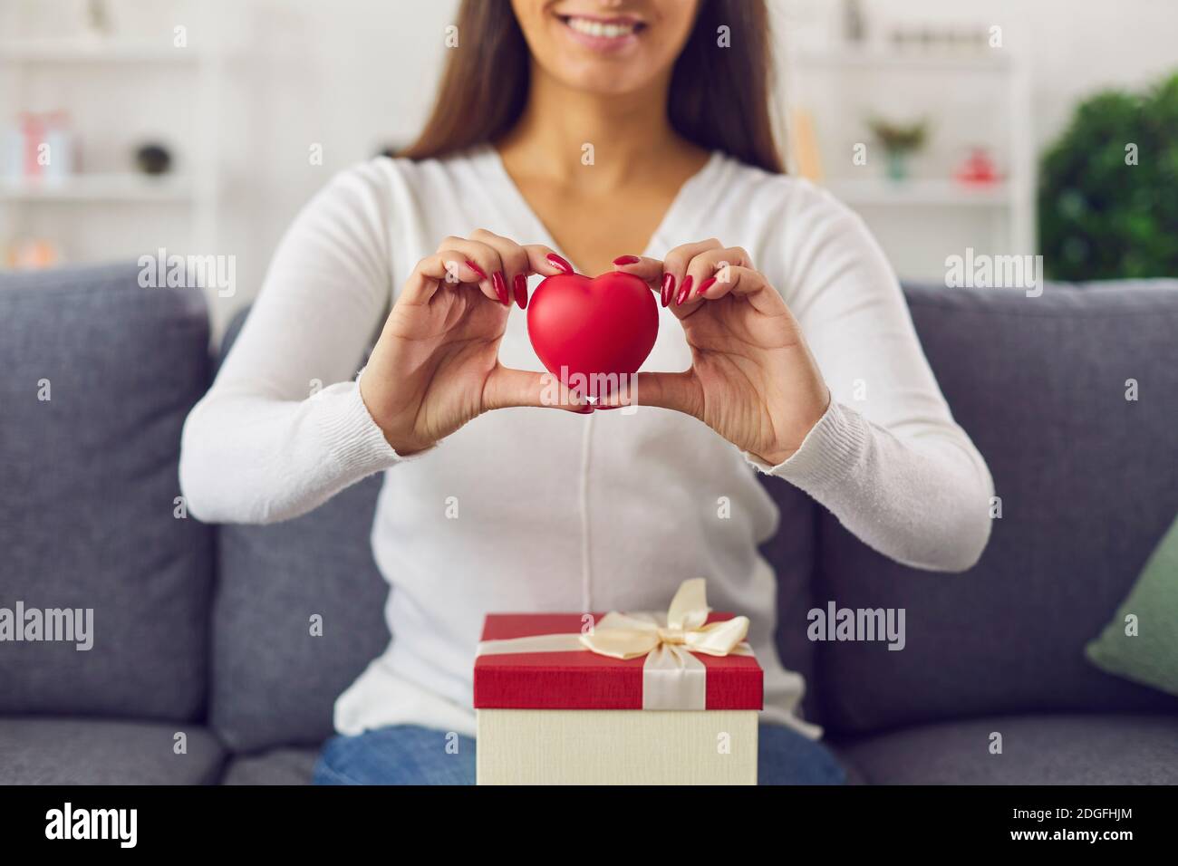 Happy woman present heart hi-res stock photography and images - Alamy