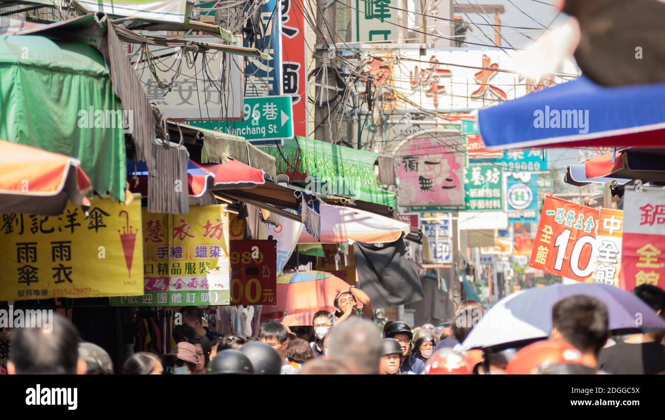 People walk and shopping in the traditional market at Puli town Stock ...