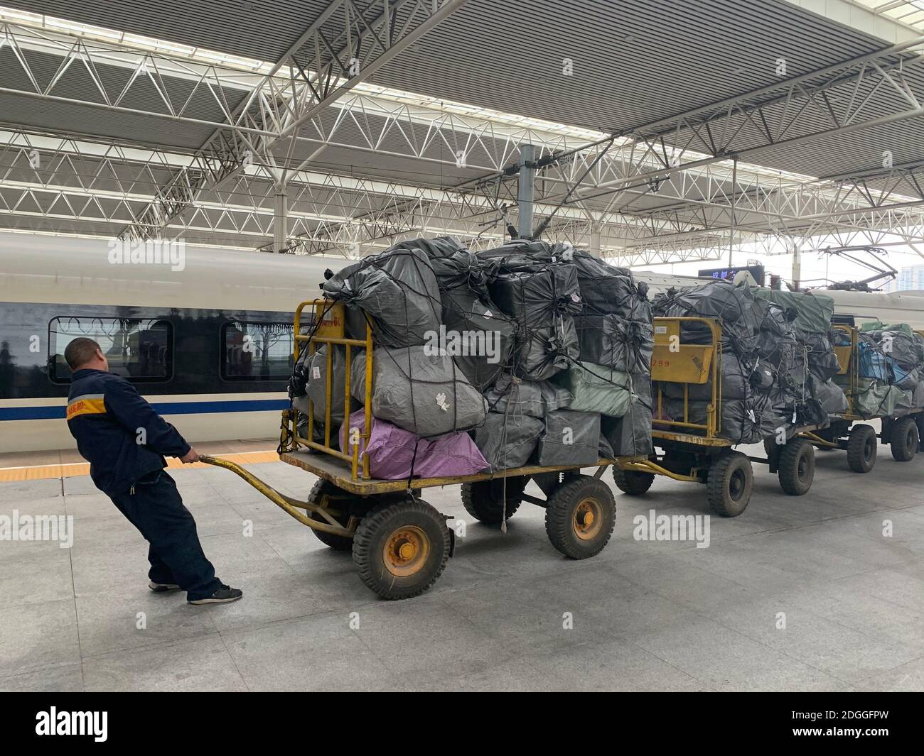 Staff carry loads of deliveries ready to be transferred to a high-speed ...