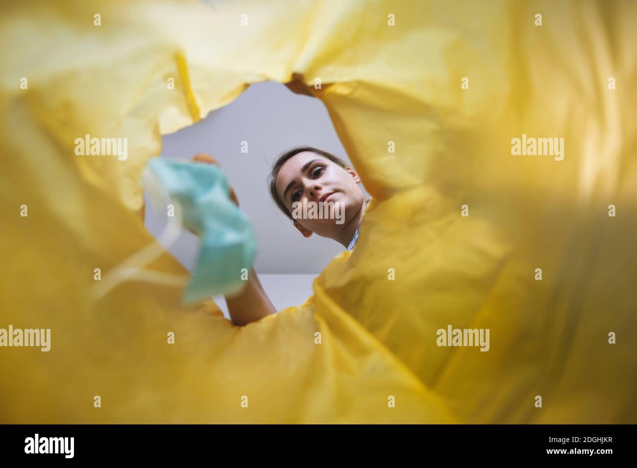 woman throwing medical face mask in trash bin Stock Photo - Alamy