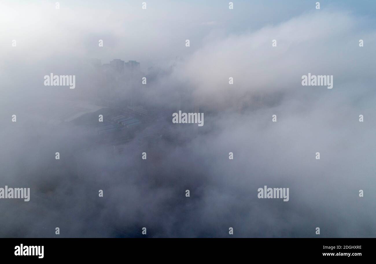 --FILE--An aerial view of the first fog in winter when the buildings of ...
