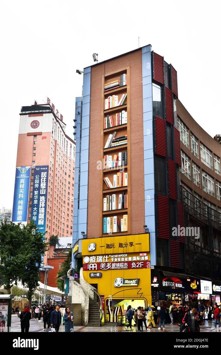 A bookshelf with huge books which are 2 meters high and 1.5 meters wide ...