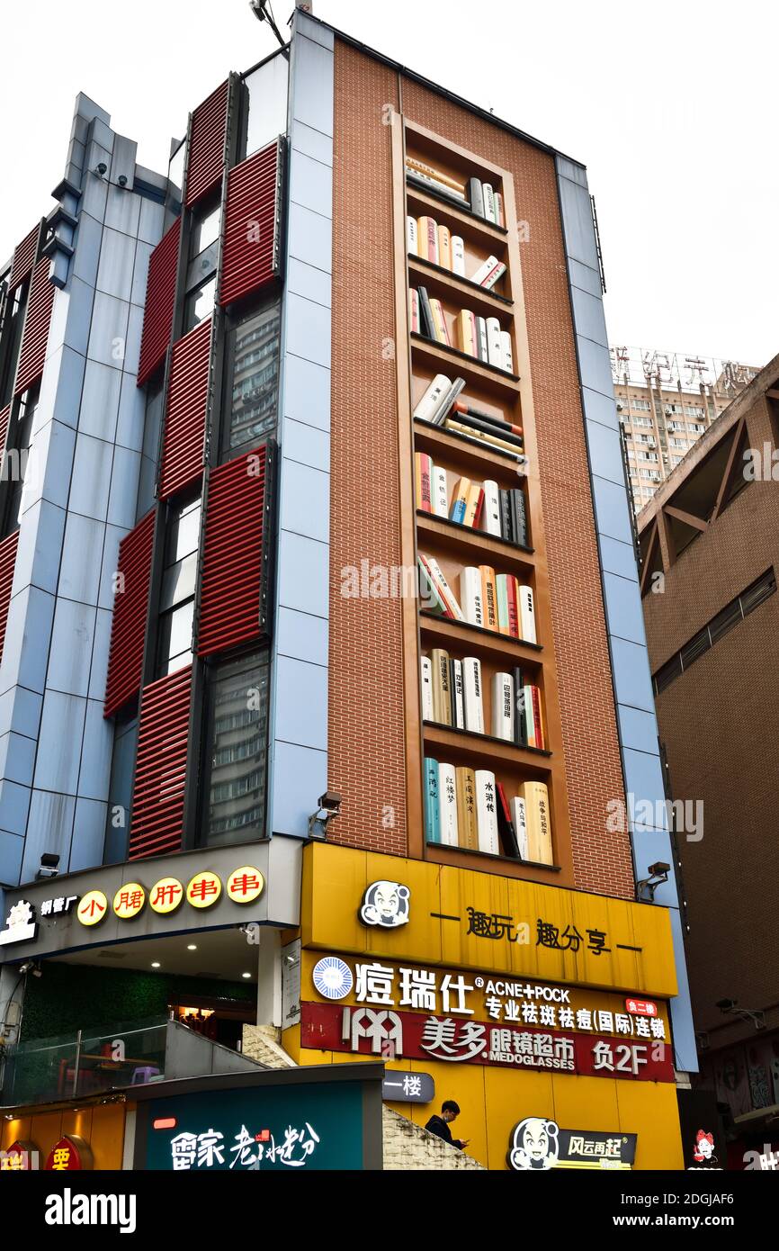 A bookshelf with huge books which are 2 meters high and 1.5 meters wide ...
