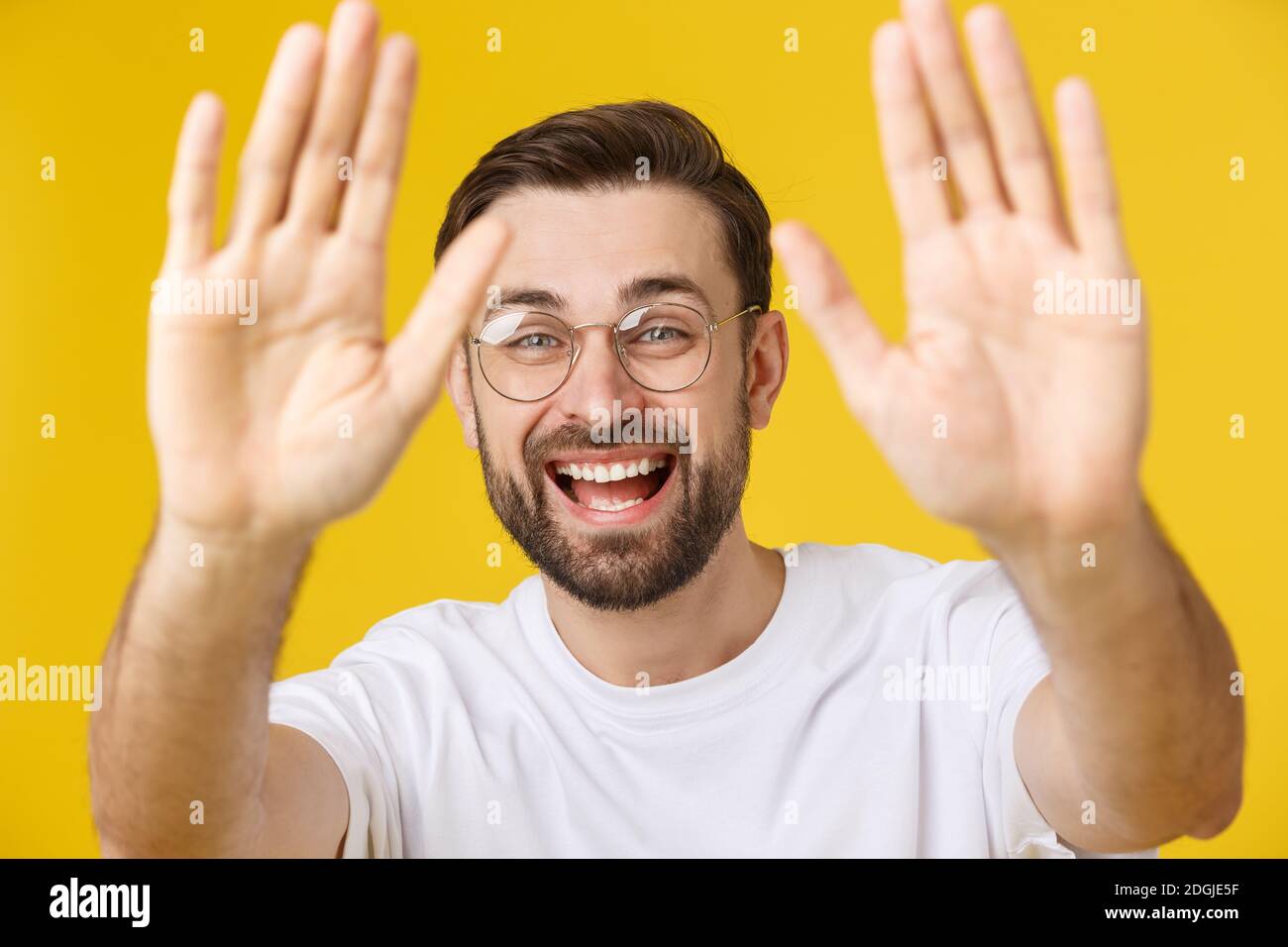 Hi, Hello. Portrait of happy friendly brown-haired man with small beard ...