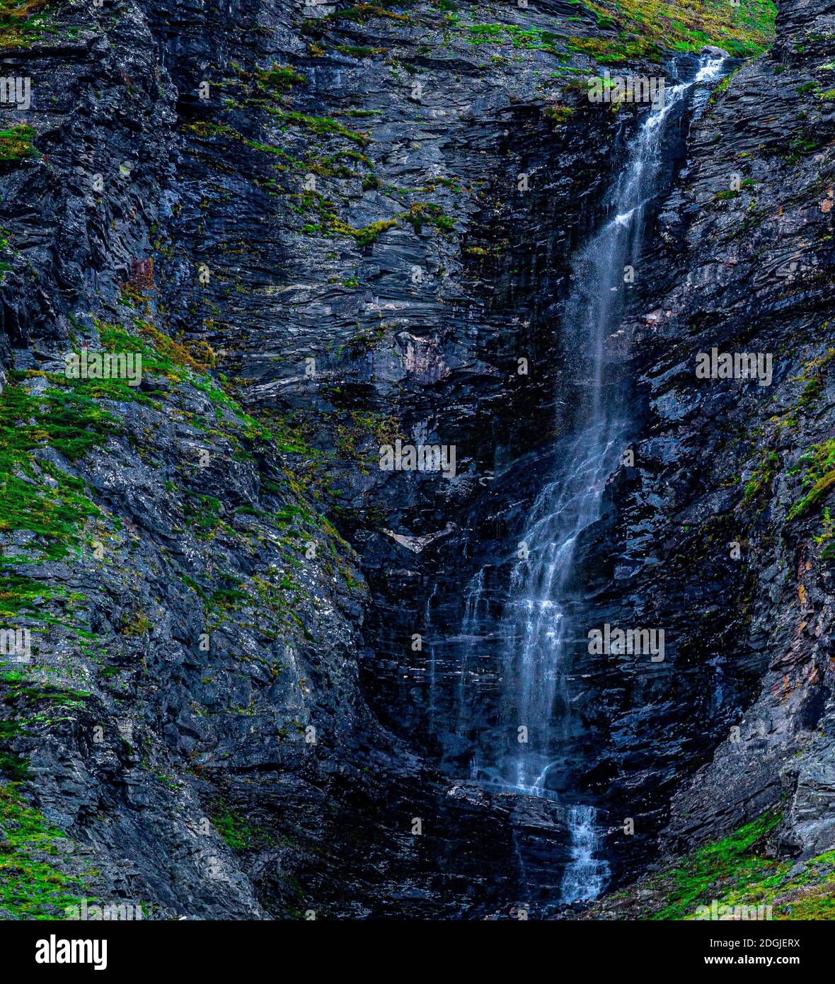Waterfall free falling from a steep mountain slope. . High quality ...