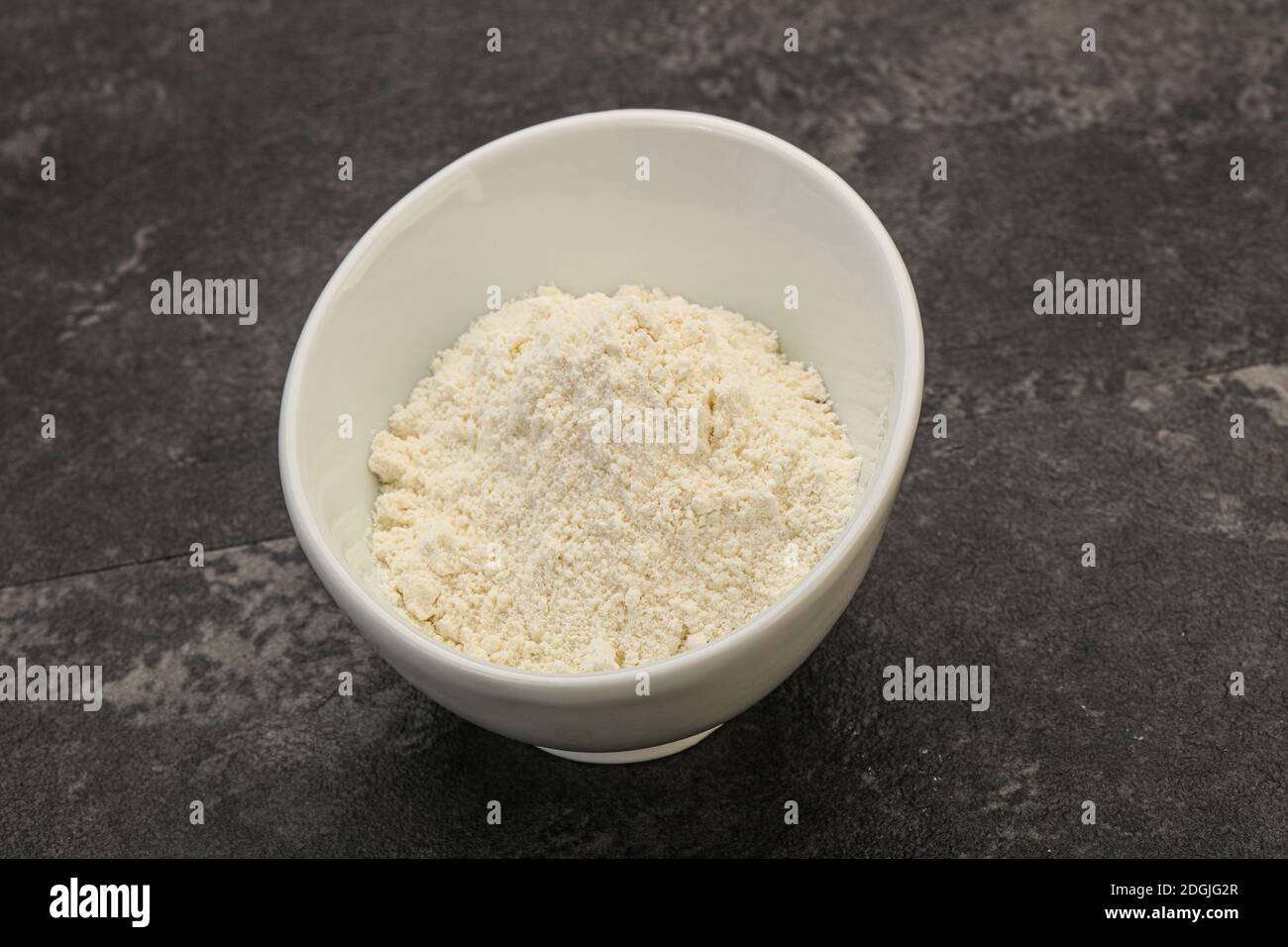 Wheat flour heap in the bowl for cooking Stock Photo - Alamy