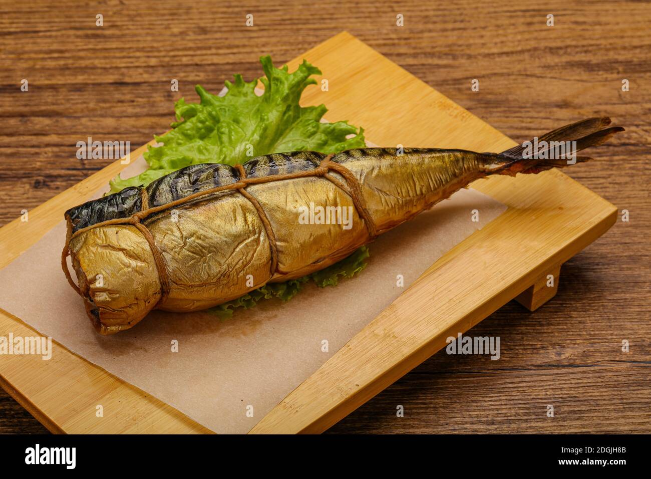 Smoked tasty mackerel fish snack over board Stock Photo - Alamy