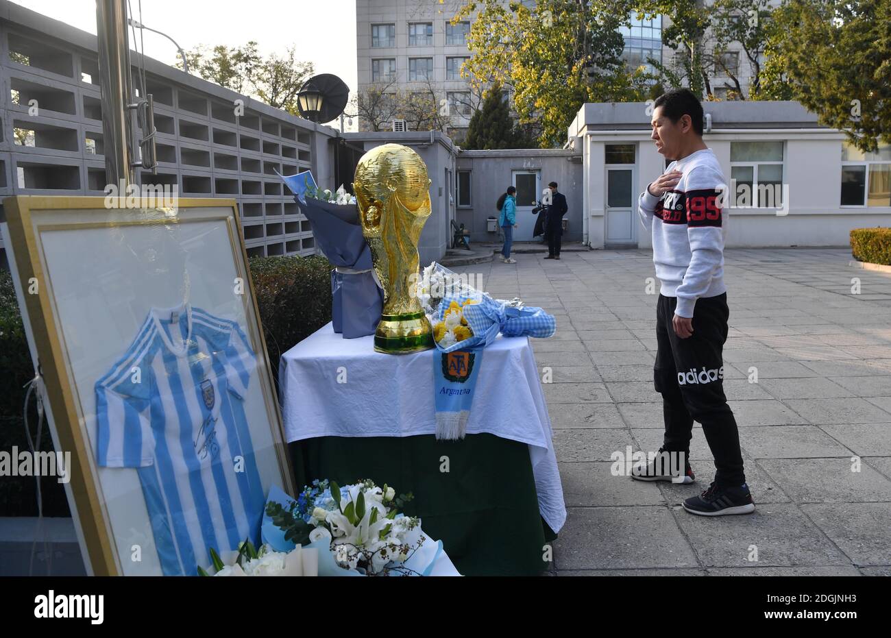 A football fan pays tribute to the memorial stall for late Argentine ...
